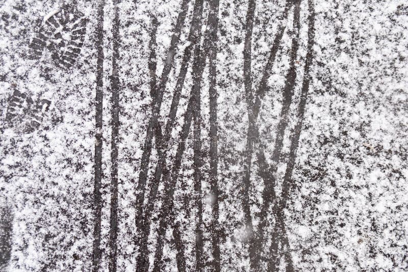Background Texture of Asphalt Road Covered with Snow and Tire Tracks ...