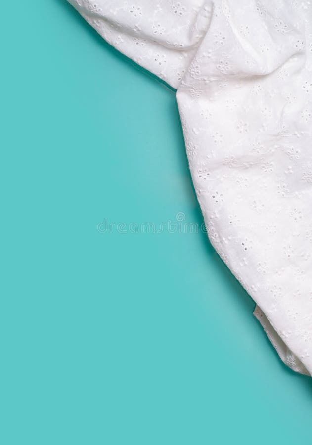The Background is Turquoise Blank with a White Cloth on the Right in ...