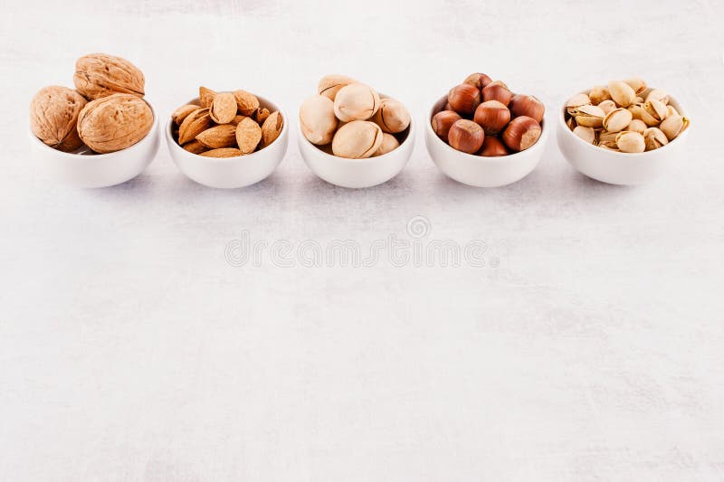 Background with Various Nuts in the Small Plates Stock Photo - Image of ...