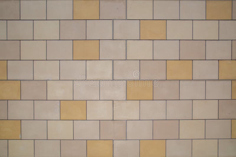 The Background of the Wall is Made of Gray and Yellow Rectangular Tiles ...