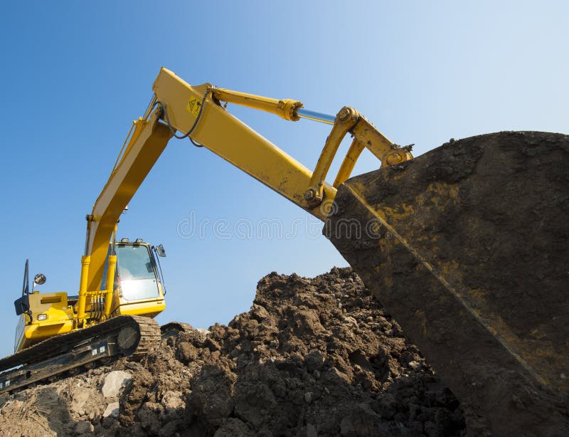 Backhoe in dirt field stock photo. Image of scoop, development - 209146000