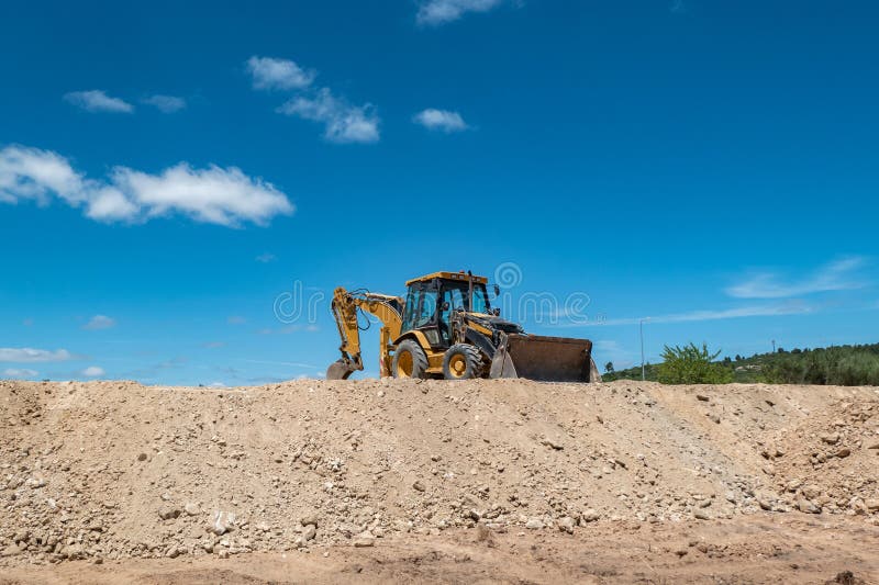 Backhoe in Action Spreading Land for Batch Construction Stock Image ...