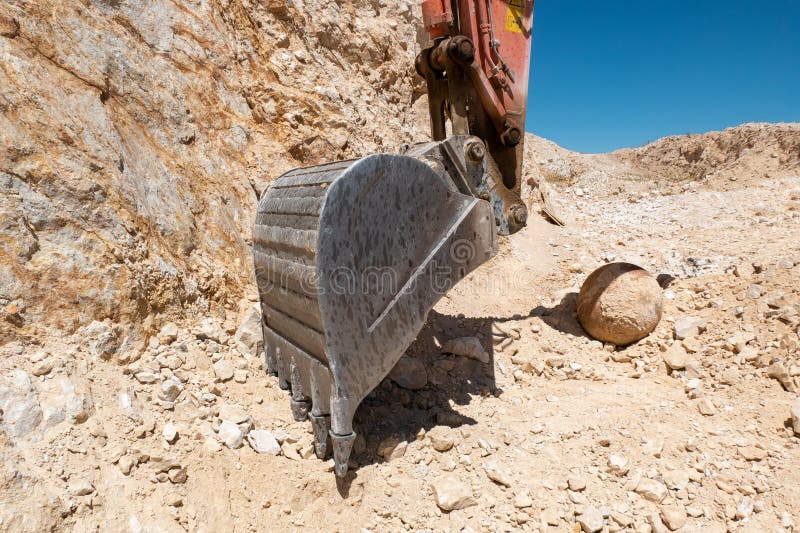 Backhoe in Action Excavating Soil in a Quarry Stock Photo - Image of ...