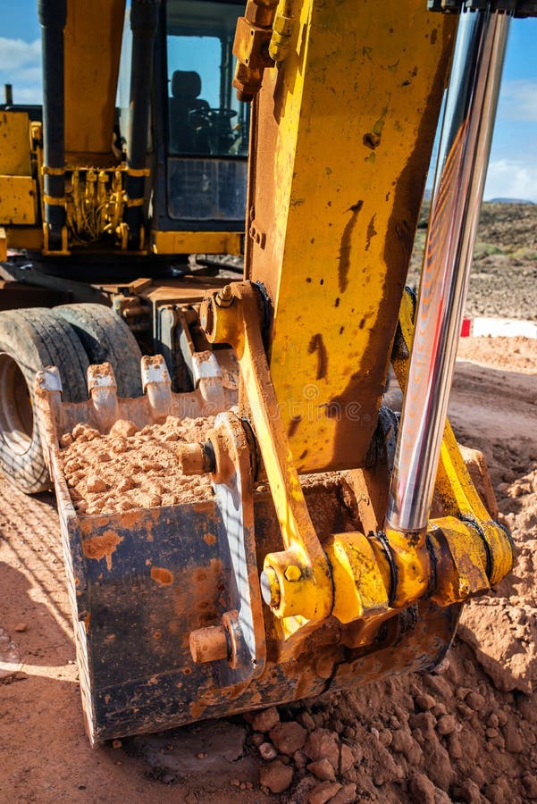 Backhoe Digging in Dust Close Up Stock Photo - Image of yellow, street ...