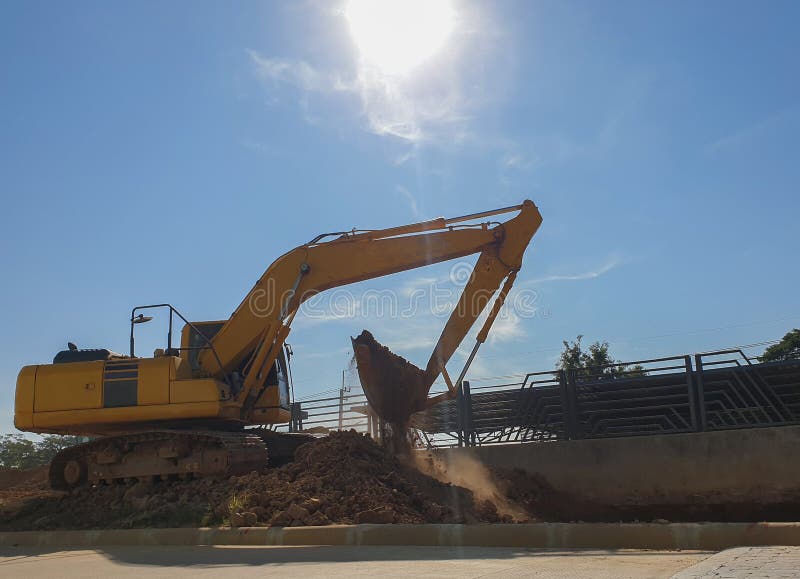 Backhoe Digging in the Factory Under the Sun Stock Photo - Image of ...