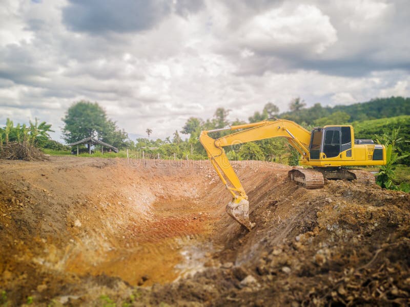 Backhoe digging a pool stock photo. Image of garden - 192653444