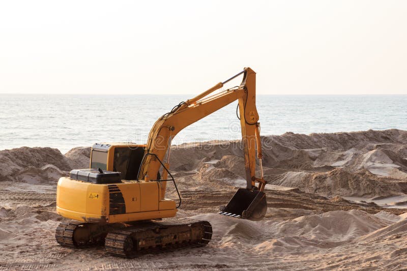 Backhoe Digging in the Sand Stock Photo - Image of surge, disaster ...