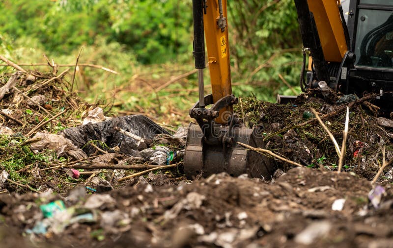 Digger Working by Digging Soil at Construction Site. Bucket Teeth of ...