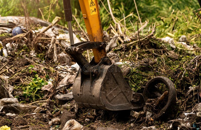 Digger Working by Digging Soil at Construction Site. Bucket Teeth of ...