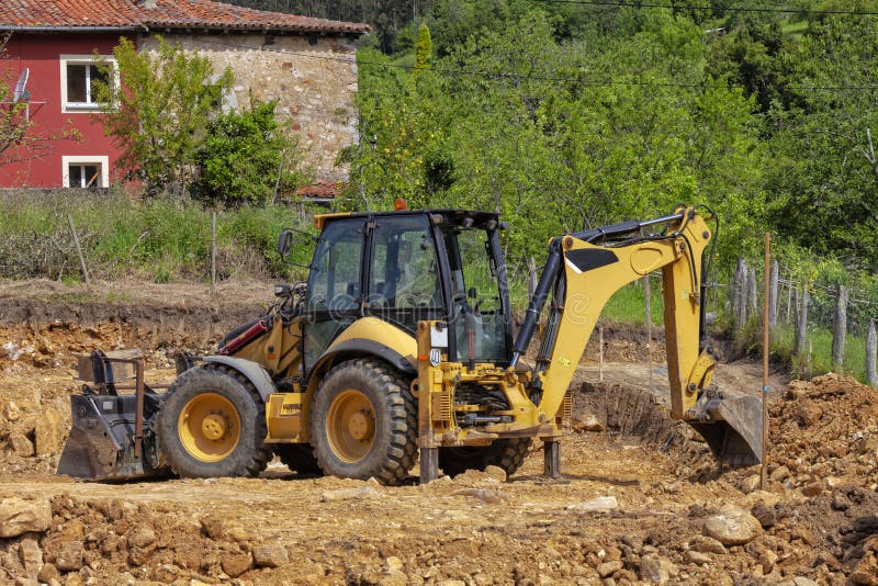 Backhoe Excavating Earth in a Construction Site Stock Photo - Image of ...