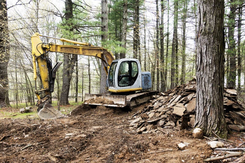 Backhoe Excavator Demolishing Building and Gathering Debris during ...