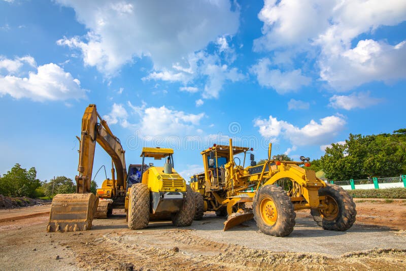 Backhoe, Grader and Road Roller on the Ground at Site Construction ...