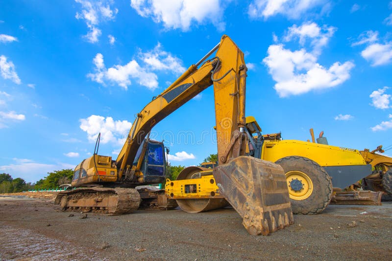 Backhoe, Grader and Road Roller on the Ground at Site Construction ...