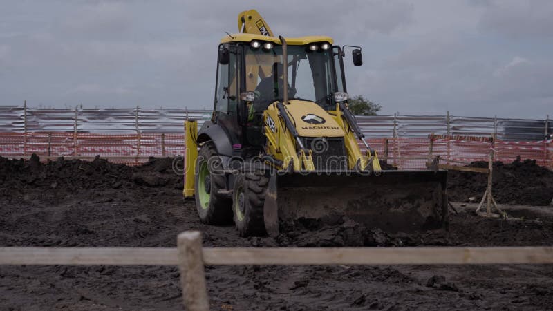 Backhoe Loader Working in a Construction Site during a Cloudy Daytime ...