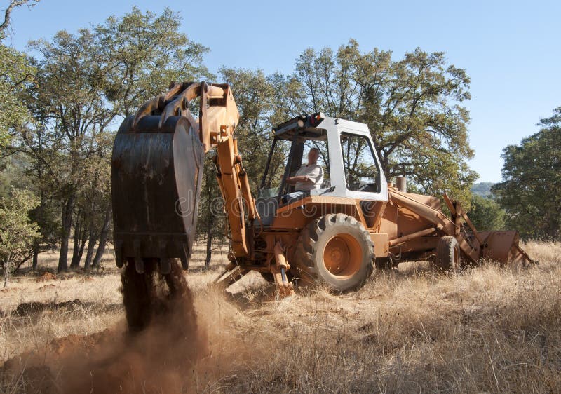 Backhoe out in the field stock photo. Image of dirt, earth - 16679724
