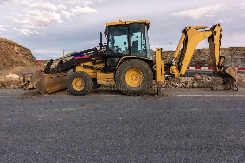 Backhoe in Construction Tasks of a Road. Preparation of the Land for ...