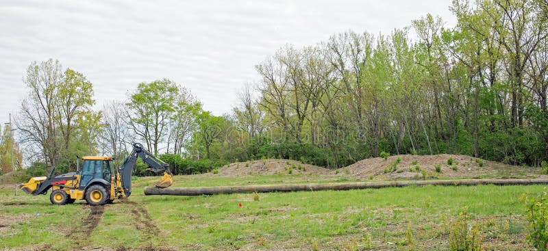 Backhoe Ready To Pull 80 Foot Utility Pole into Place Stock Photo ...