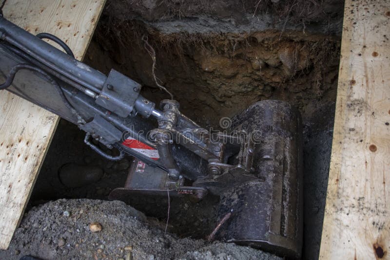 A backhoe in a trench stock photo. Image of machine - 148631992