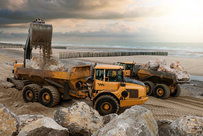 Large Hydraulic Excavators and Dumpers Working As a Team on a ...