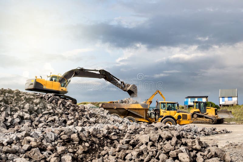 Large Hydraulic Excavators Working As a Team on a Construction Site ...