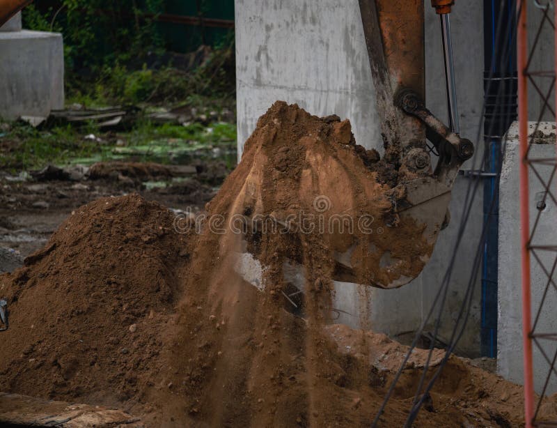 Digger Working by Digging Soil at Construction Site. Bucket Teeth of ...