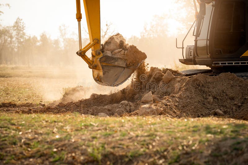 Backhoe Working by Digging Soil at Construction Site. Crawler Excavator ...