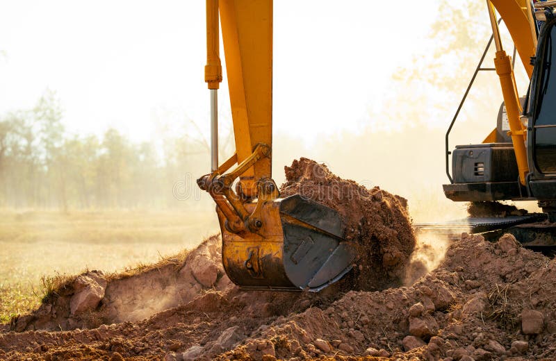 Backhoe Working by Digging Soil at Construction Site. Crawler Excavator ...