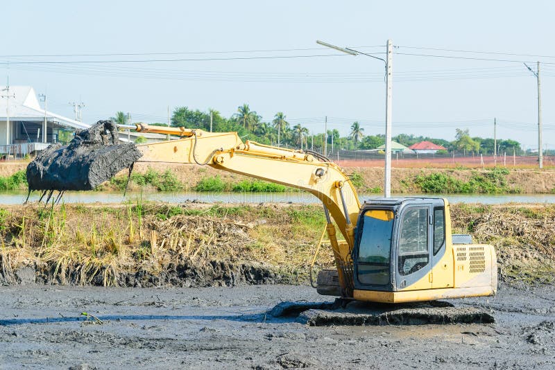 Backhoe Working in Mud Swamp Stock Photo - Image of mining, excavator ...