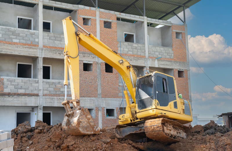 Backhole Loader Digging Drainage Ditch and Laying Concrete Pipeline ...
