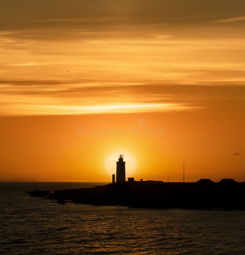 Lighthouse at Sunset with Sun in the Background Stock Photo - Image of ...