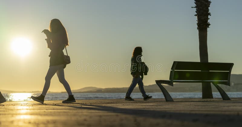 Backlit people walking stock photo. Image of summer - 171154594