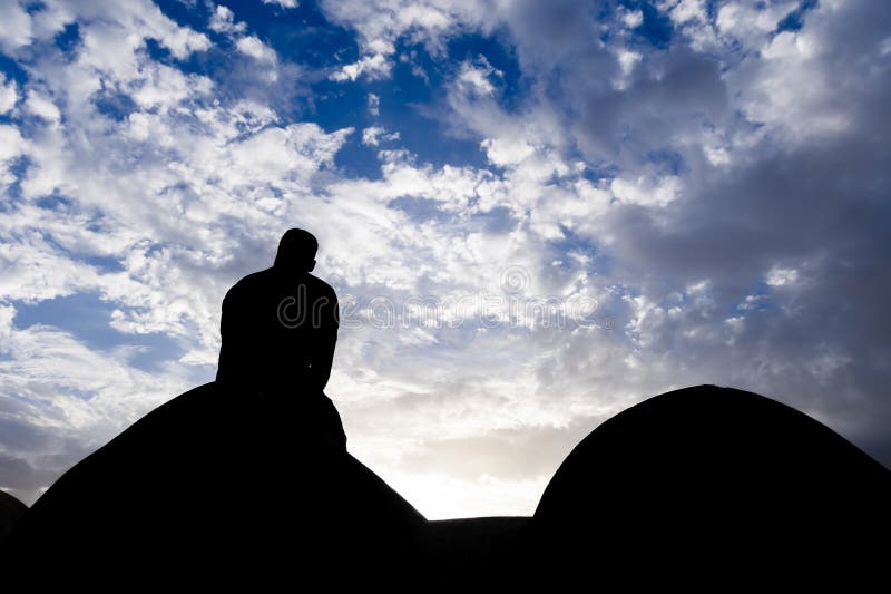 Backlit Shot of Isolated Man Sitting at Wall Watching Sunset with ...