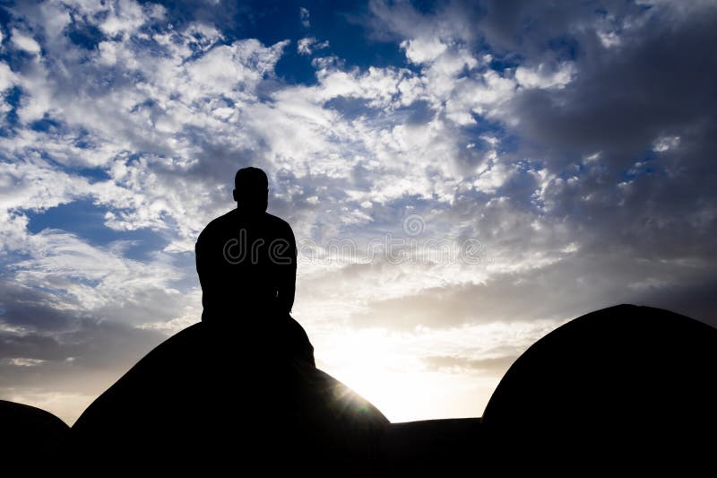 Backlit Shot of Isolated Man Sitting at Wall Watching Sunset with ...