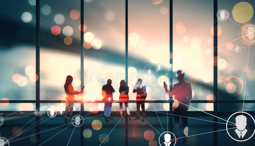 Backlit Team Working Together in Dark Office Interior with Windows ...