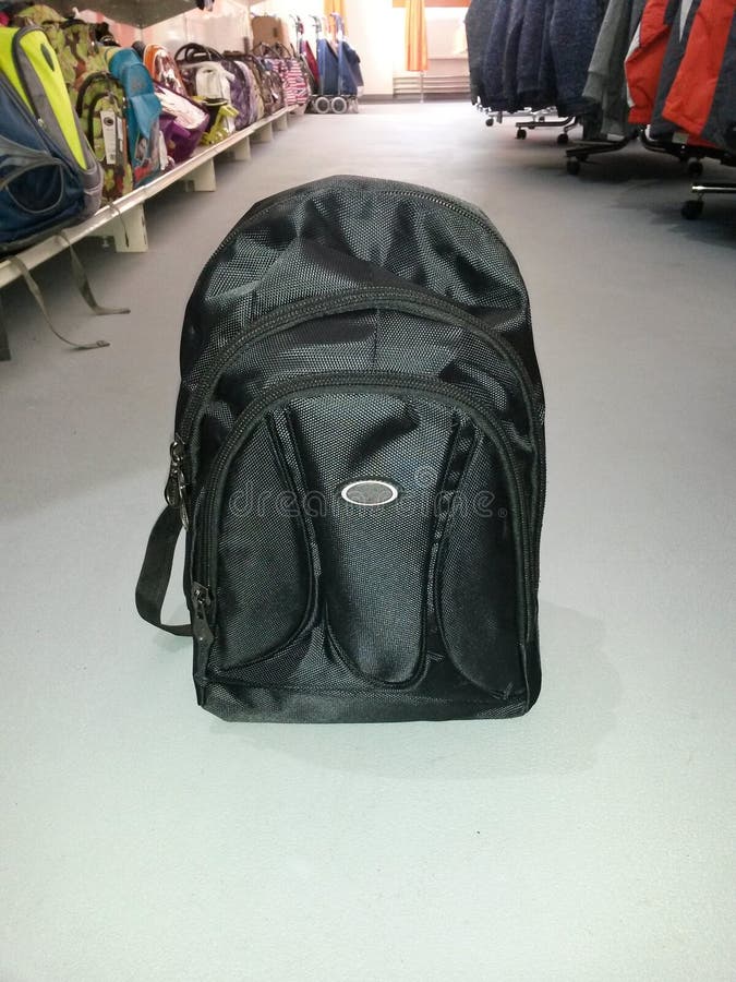 Backpack Black on the Ground in Backpacks and Clothes Store Stock Photo ...