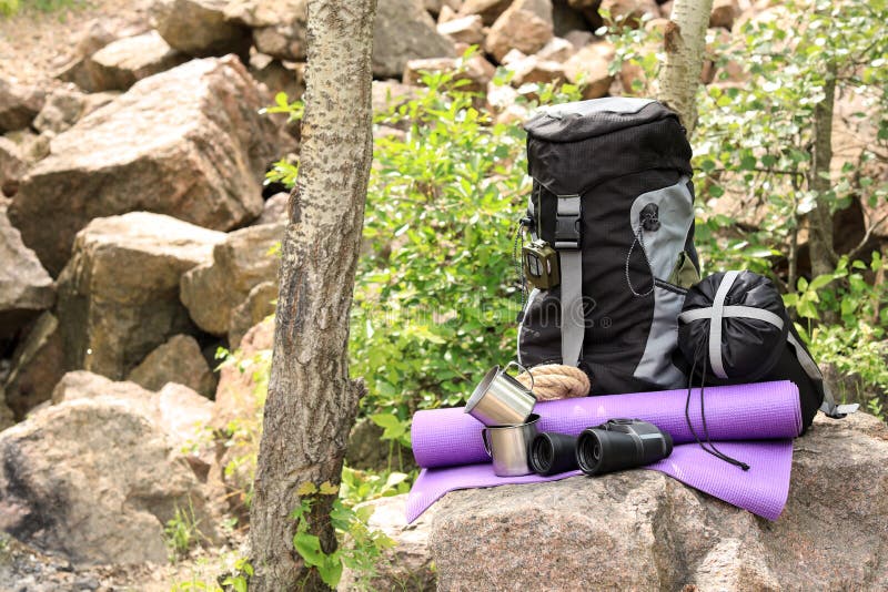 Backpack and Camping Equipment on Stone in Forest Stock Image - Image ...