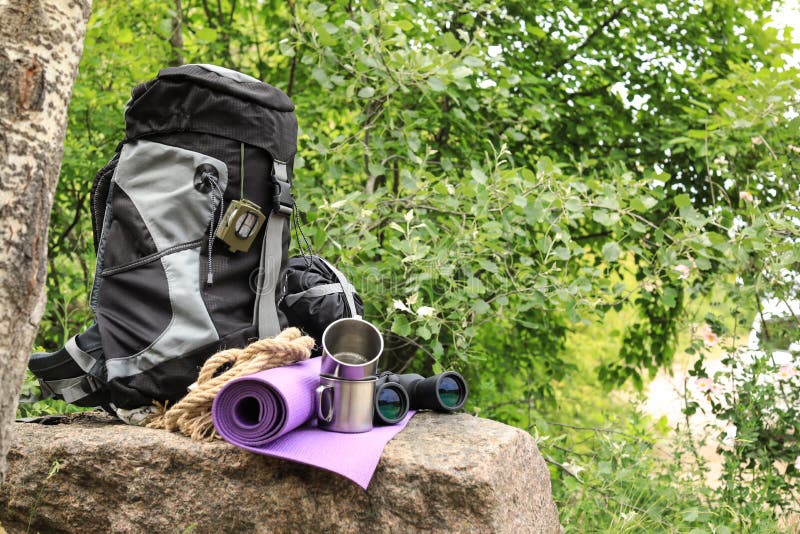 Backpack and Camping Equipment on Stone in Forest Stock Photo - Image ...