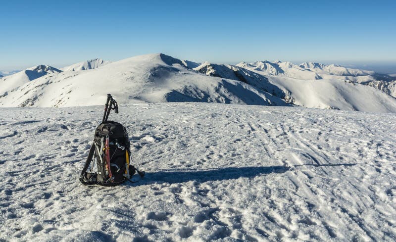 Backpack with Ice Axes and Trekking Poles in Winter in the Mount Stock ...