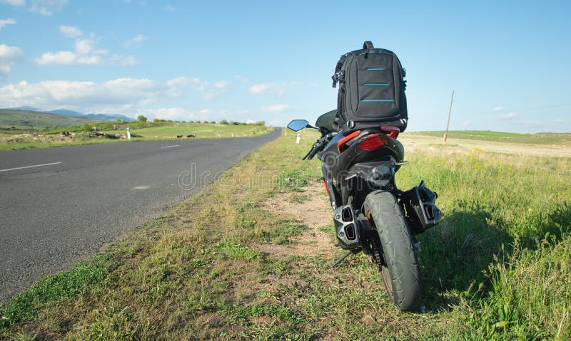 Backpack with a Motorcycle at Outdoors. Ready for Adventure and Travel ...
