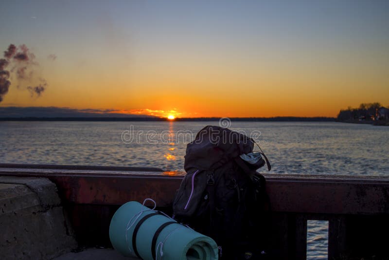 Backpack in the sunset stock photo. Image of leisure - 63189606