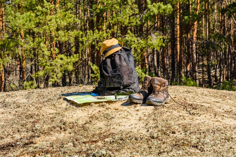 Backpack, Touristic Boots, Map, Compass and Hat on a Ground in a ...