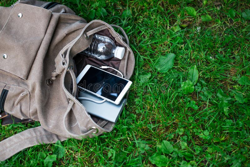 Backpack with Water, Mobile Phone and Powerbank Inside Stock Photo ...