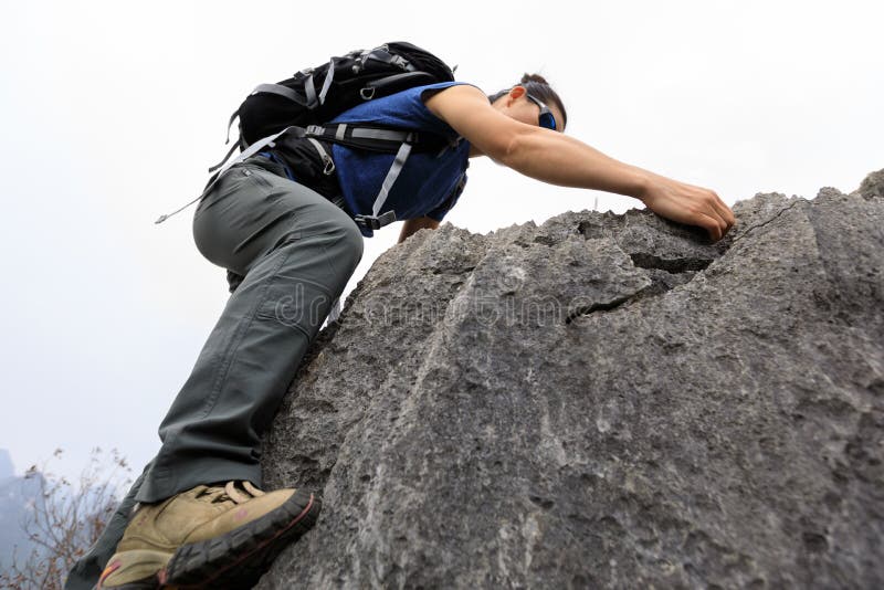 Backpacker Climbing Rock on Mountain Top Cliff Edge Stock Photo - Image ...
