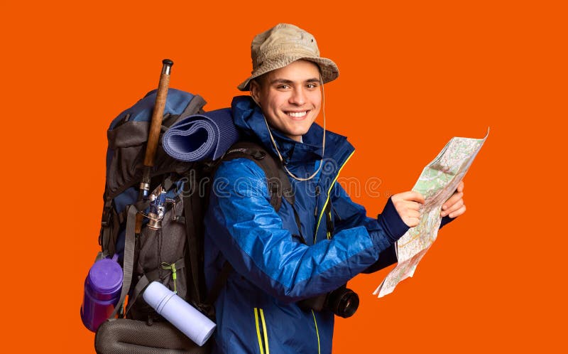 Backpacker Following Map, Smiling Over Orange Background Stock Image ...