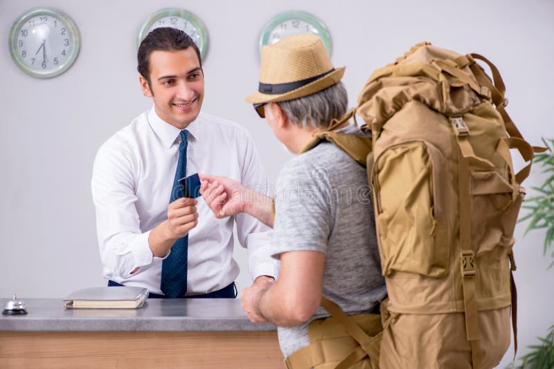 Backpacker at the Hotel Reception Stock Photo - Image of backpacker ...
