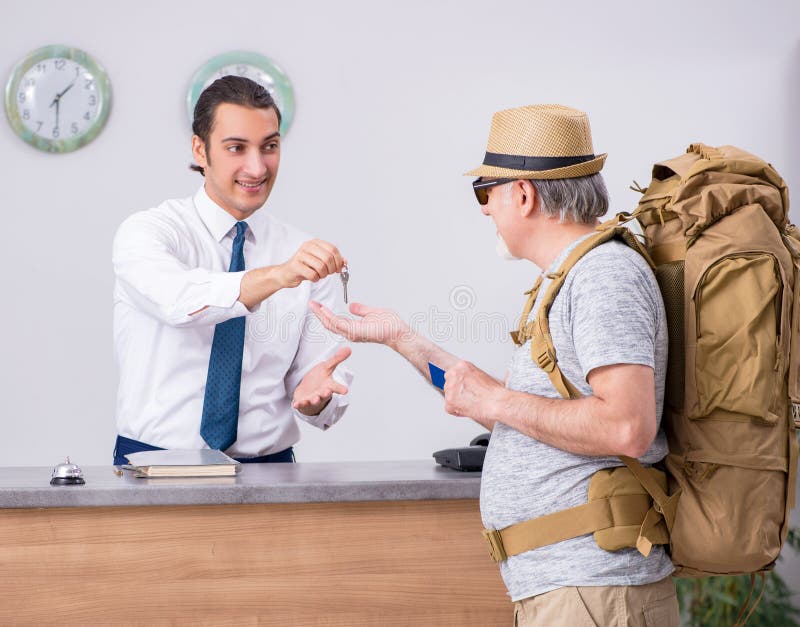 Backpacker at the Hotel Reception Stock Photo - Image of desk, giving ...