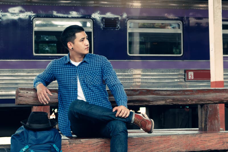 Backpacker Man Sitting on Bench Waiting at Train Station Stock Image ...
