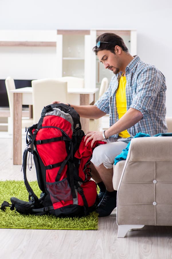 The Backpacker Packing for His Trip Stock Photo - Image of packing ...