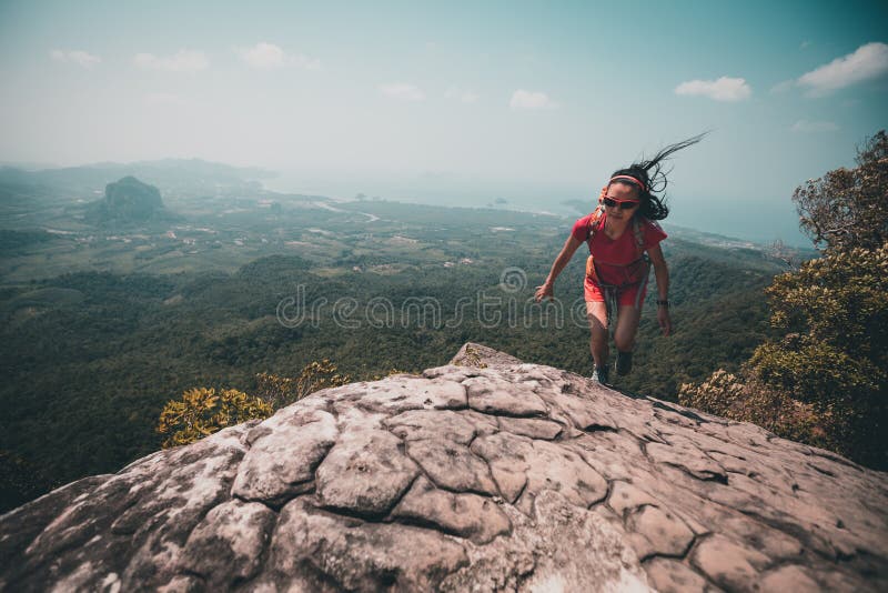 Backpacker Running Up on Mountain Top Cliff Edge Stock Photo - Image of ...