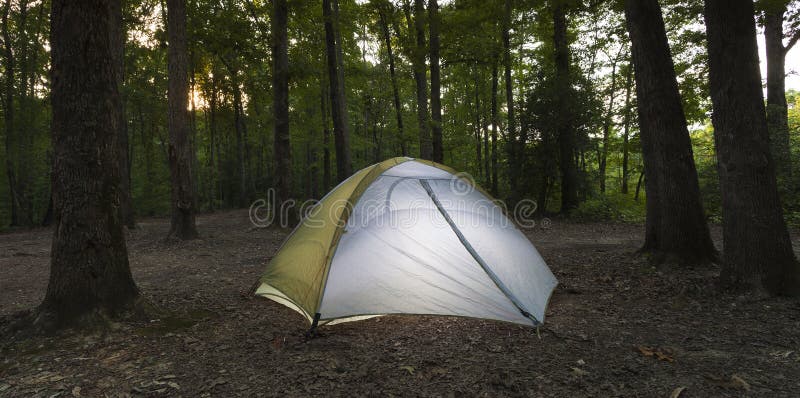Backpackers camp at sunset stock photo. Image of forest - 109195802